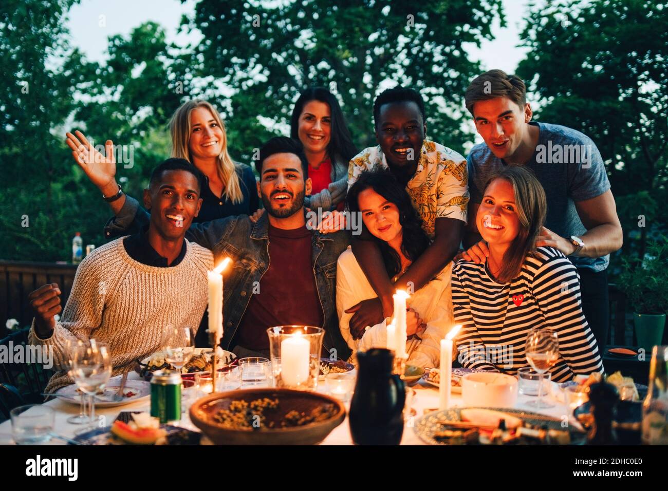 Portrait of cheerful male and female friends enjoying dinner party ...