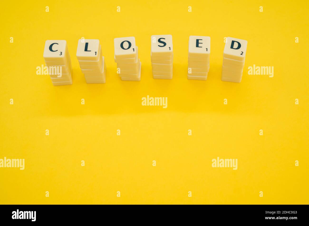 The six white letter block stacks forming the word CLOSED on yellow ...