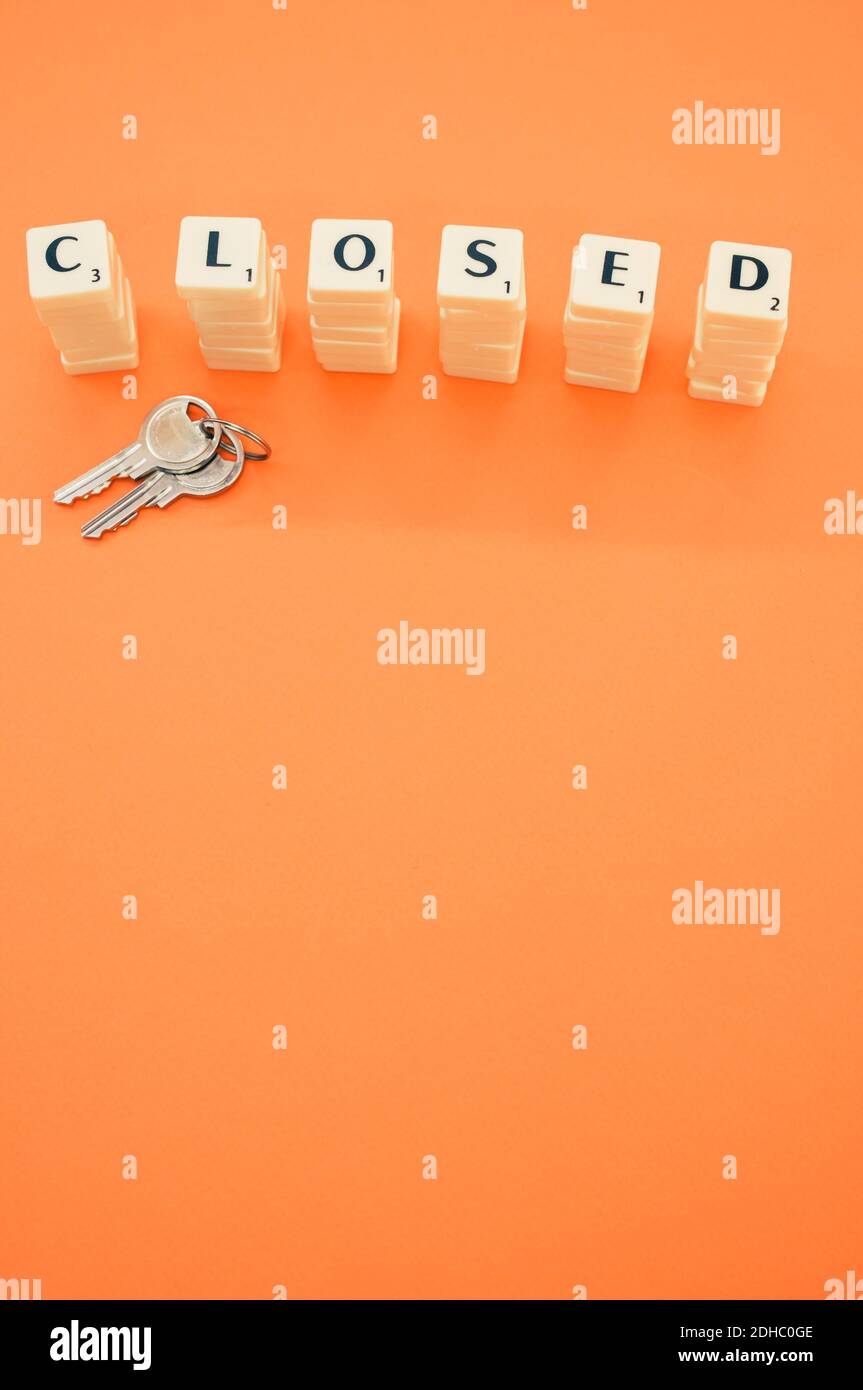 The six white letter block stacks forming the word CLOSED with keys on ...