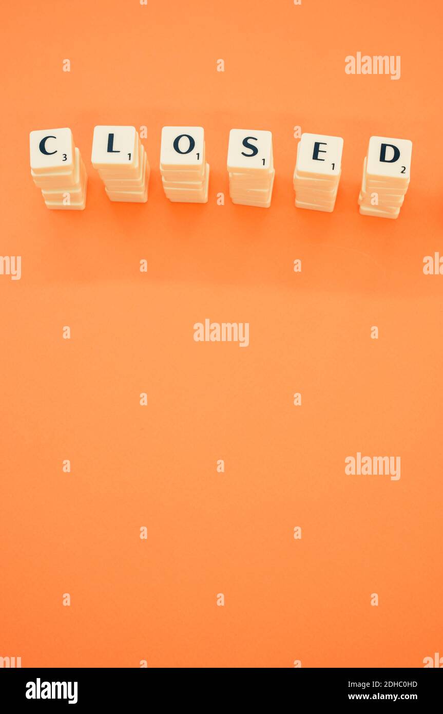 The six white letter block stacks forming the word CLOSED on orange ...