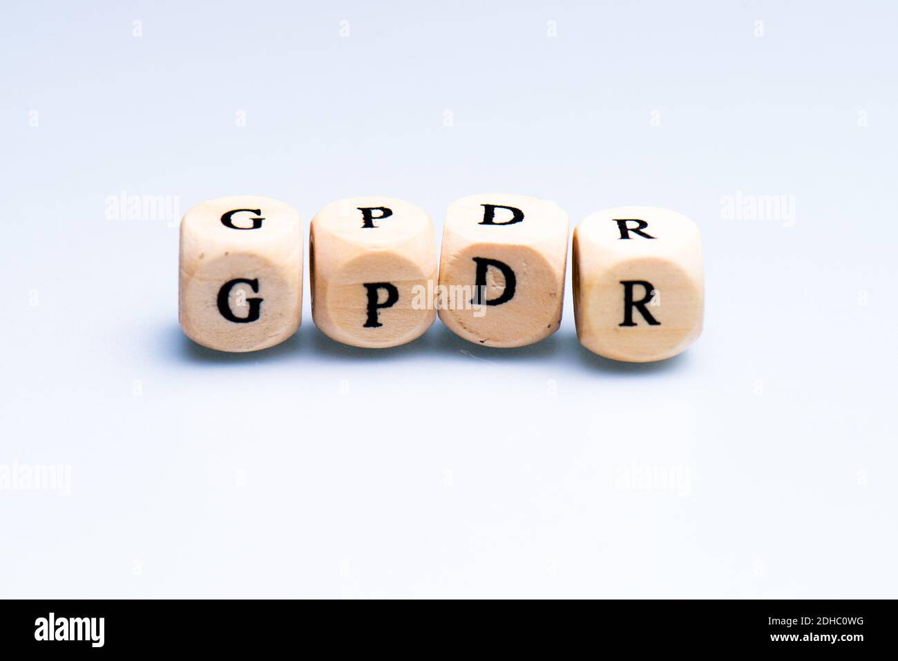 Closeup picture of wooden dice with letters GPDR put side by side on an ...