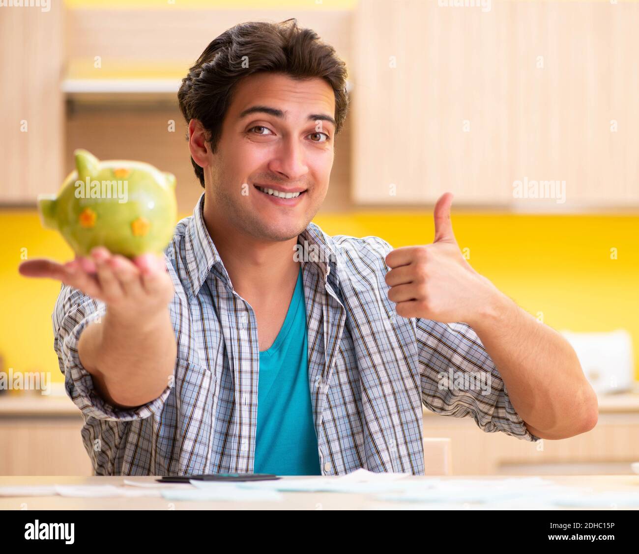 Young man husband in budget planning concept Stock Photo - Alamy