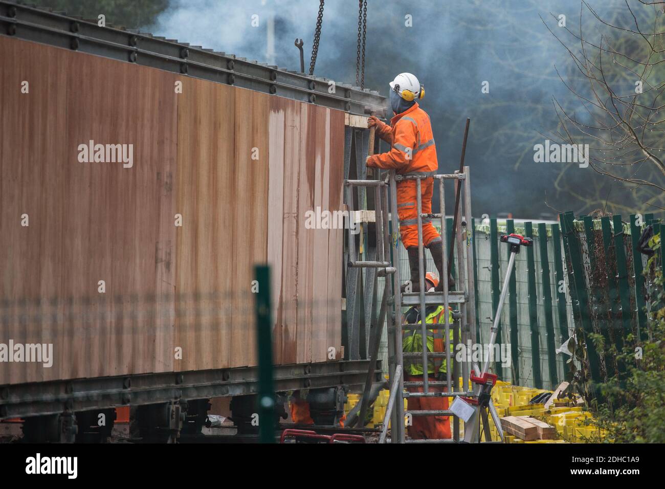 Denham, UK. 8th December, 2020. A HS2 contractor uses a large hammer in ...