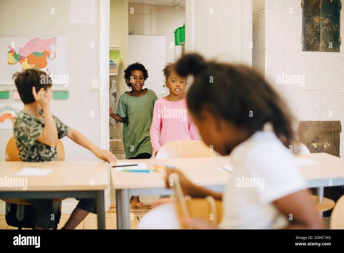 Excited students entering in classroom at elementary school Stock Photo ...