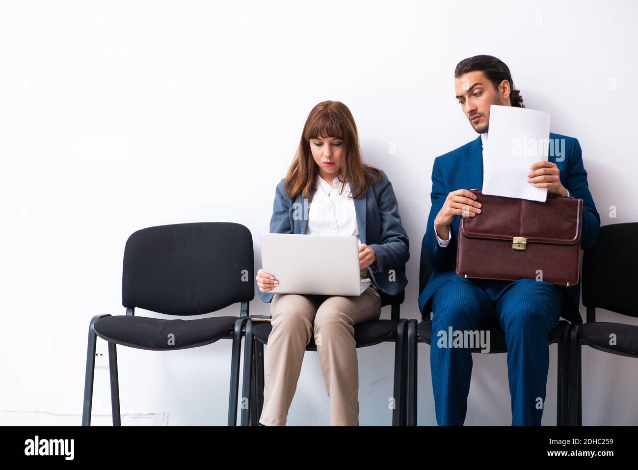 Young businessman and businesswoman waiting for an interview at Stock ...