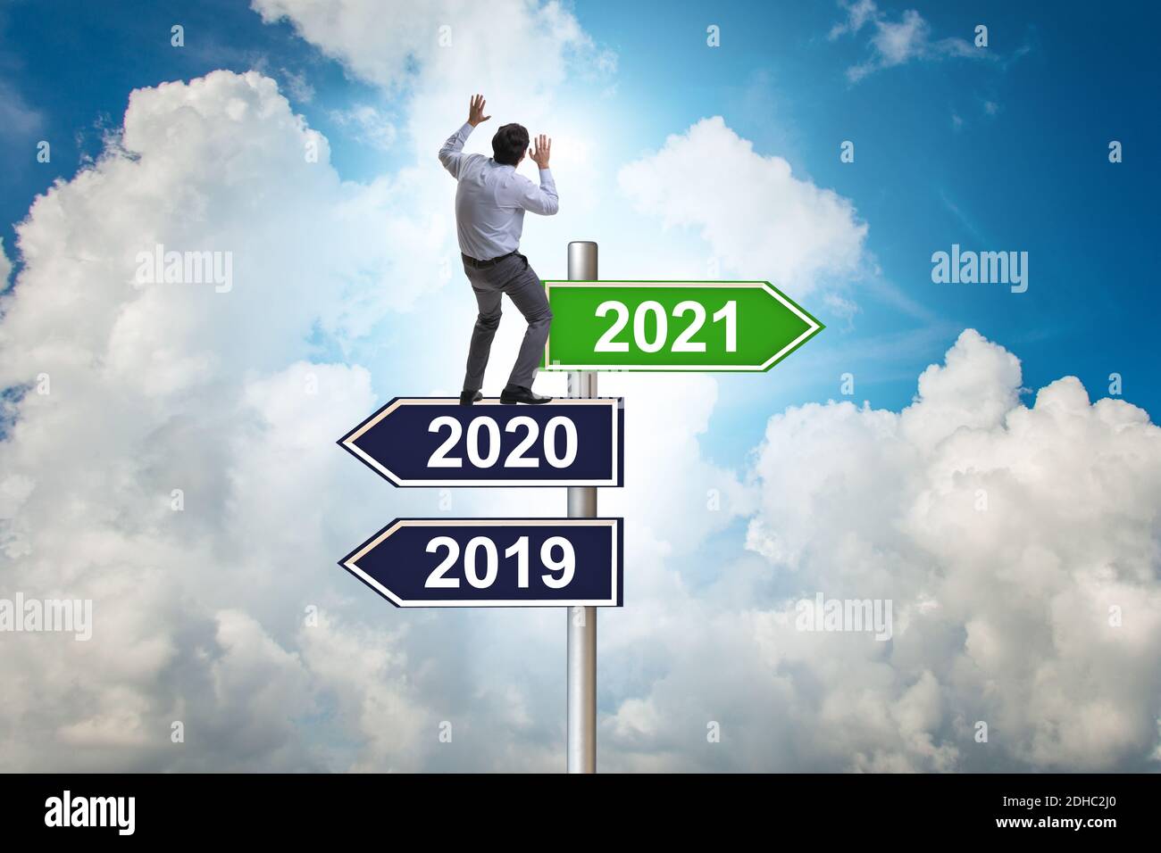 Road sign and businessman with 2020 and 2021 Stock Photo - Alamy