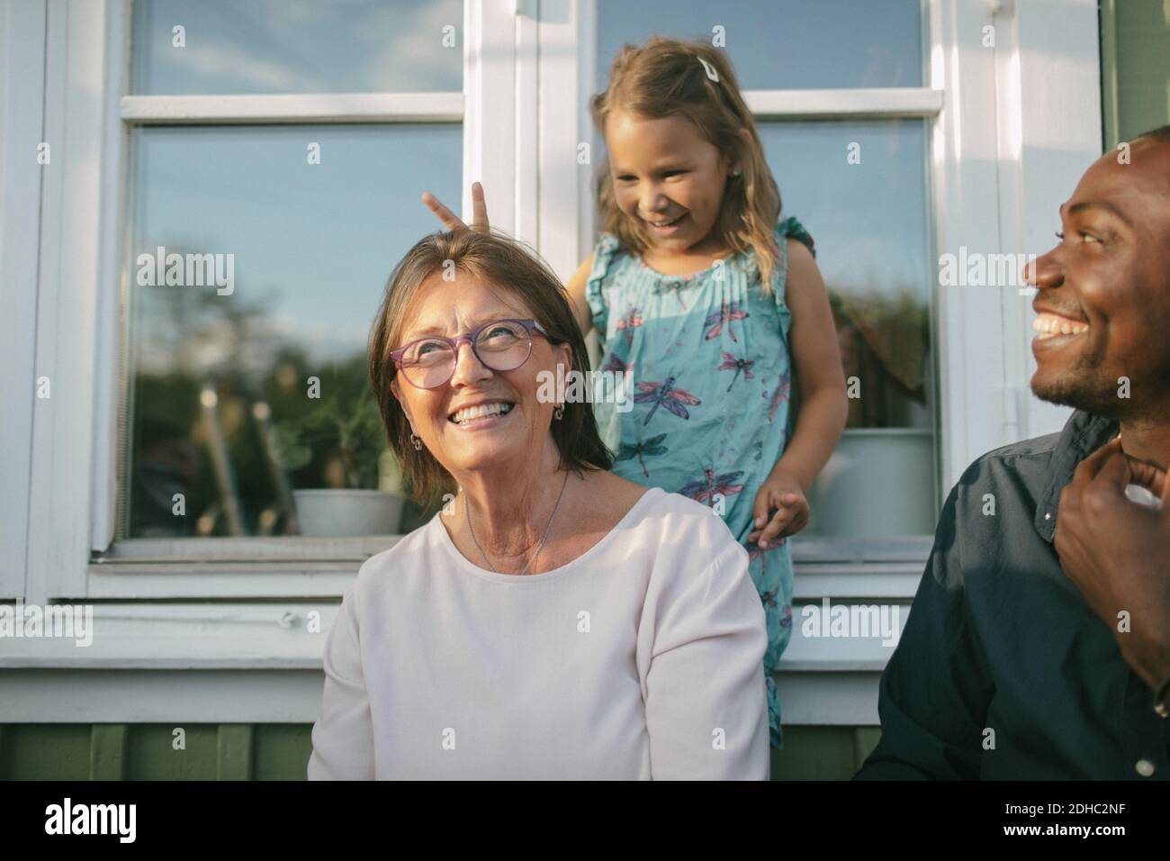 Happy multi-generation family against window at porch Stock Photo - Alamy