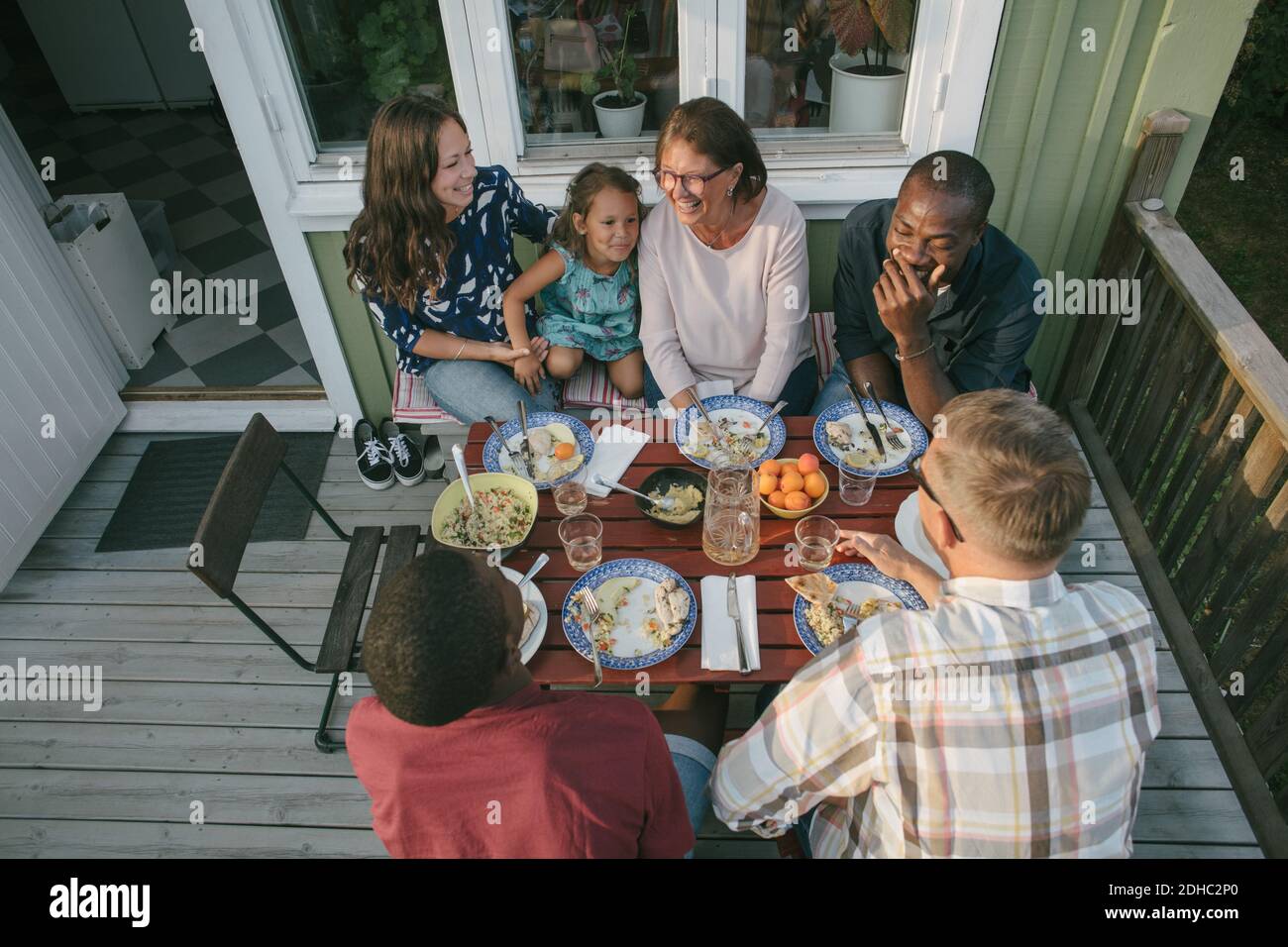 High angle view of multi-generation family having lunch at table on ...