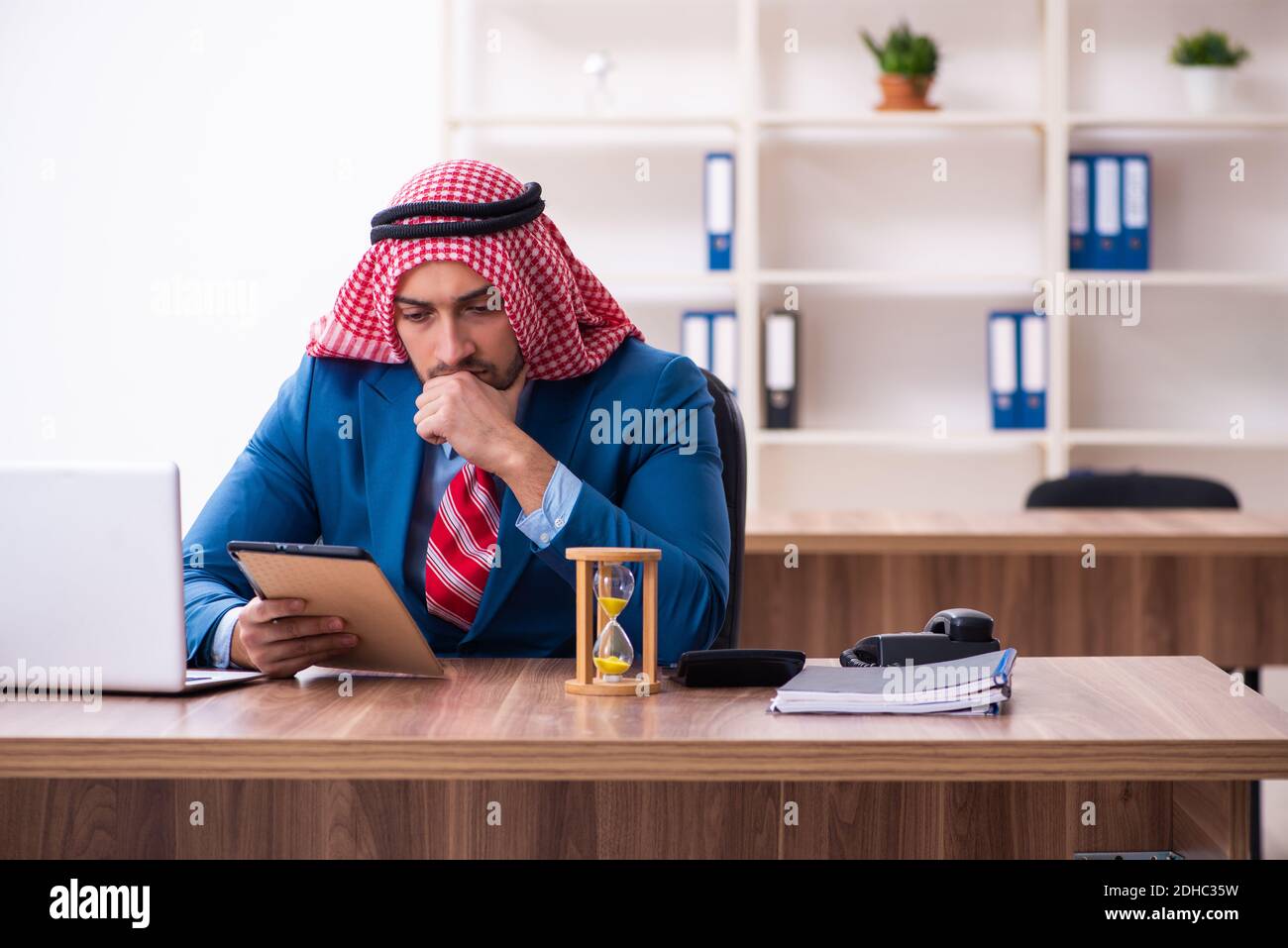 Young male arab employee working in office Stock Photo - Alamy