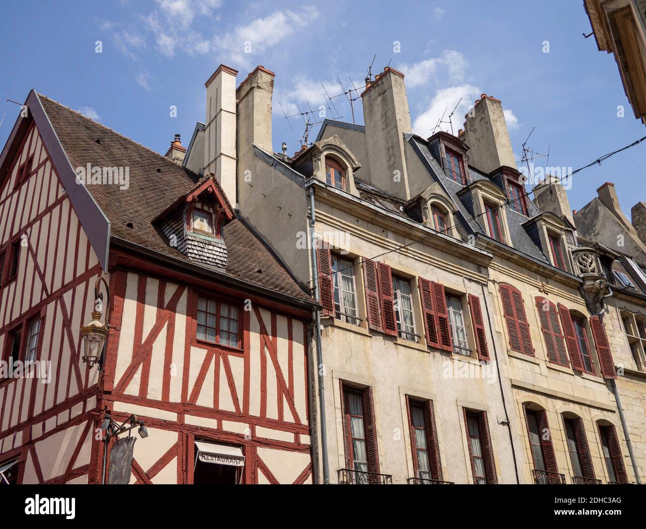 A low angle shot of a typical german residential building with chimneys ...