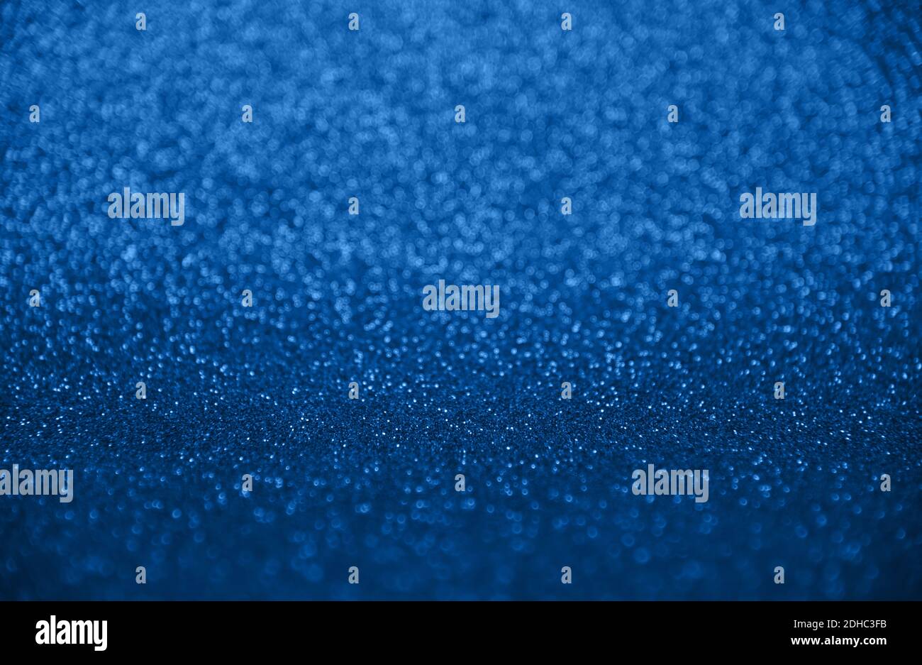 Abstract background of indigo blue bokeh defocused blurred lights and ...