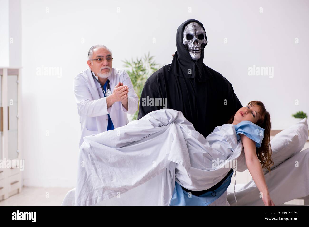 Devil, old doctor and female patient in the clinic Stock Photo - Alamy