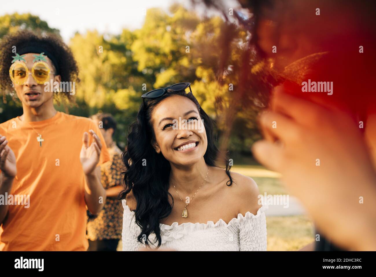 Cheerful young woman dancing with friends in music event Stock Photo ...