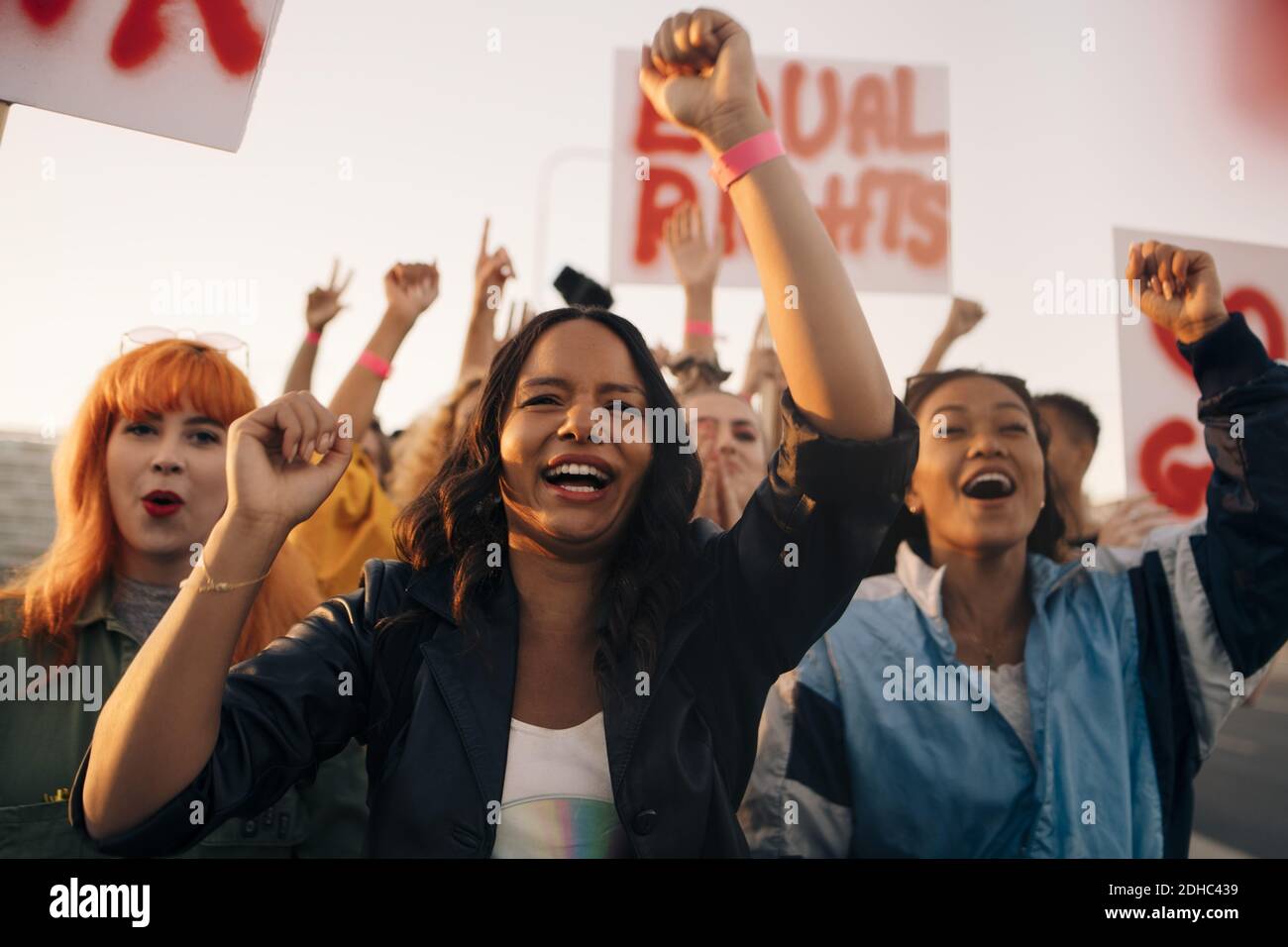 Happy women shouting for equal rights while marching together Stock ...