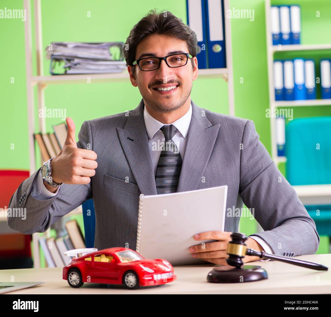 Young handsome lawyer working in the office Stock Photo - Alamy