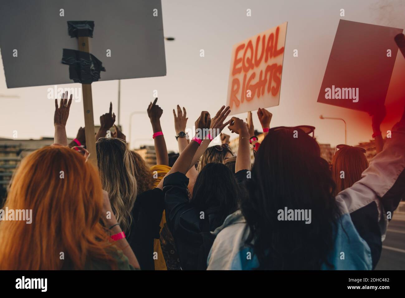Rear view of young women protesting for equal rights while marching in ...