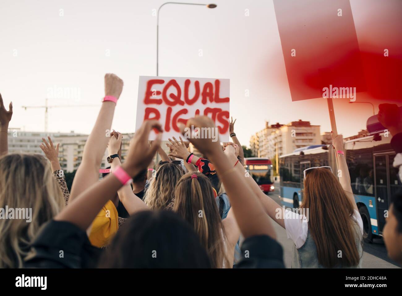 Rear view of women with banners marching for equal rights in city Stock ...