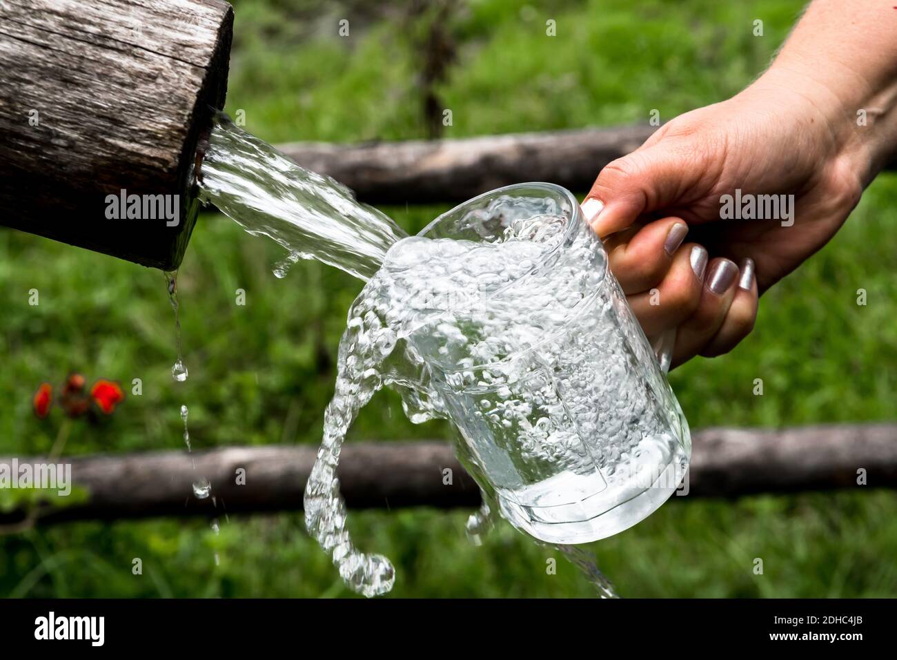 Big Glass Filled With Clear Mountain Drinking Water From A Wooden ...