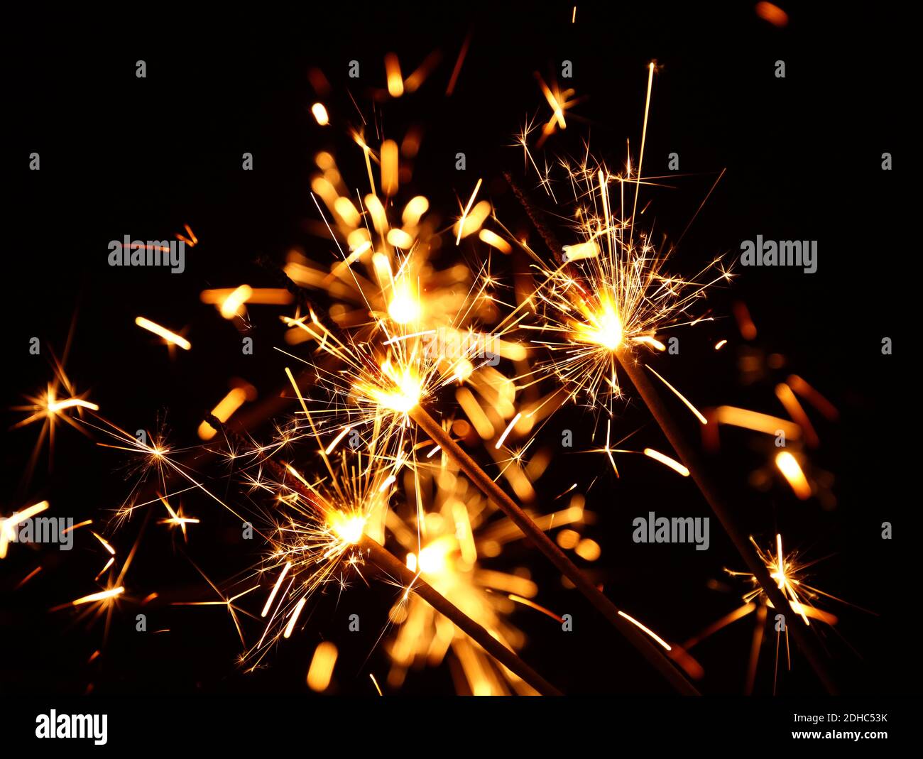 Close up group of several festive firework sparklers over black ...