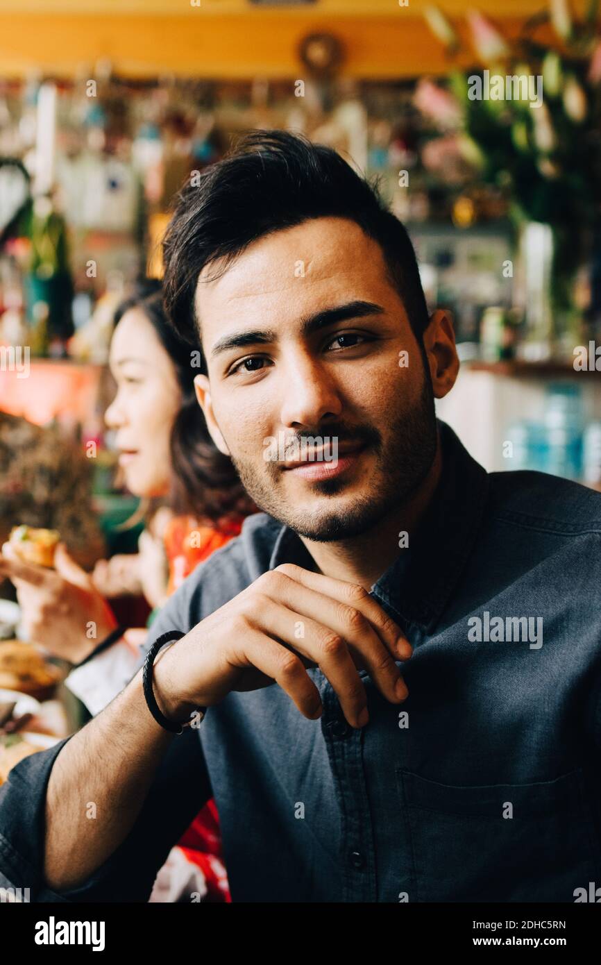 Young man sitting restaurant table hi-res stock photography and images ...