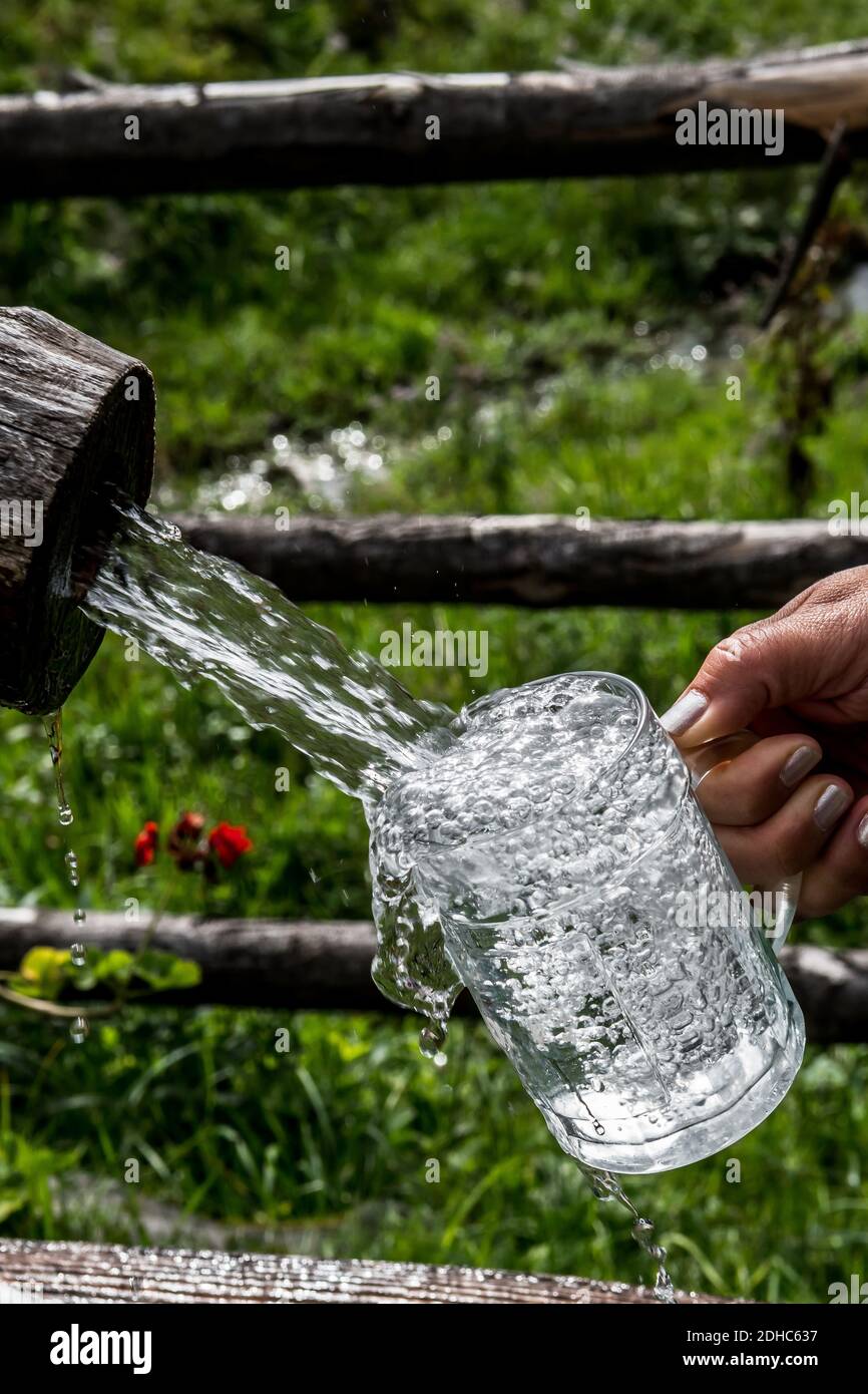 Big Glass Filled With Clear Mountain Drinking Water From A Wooden ...