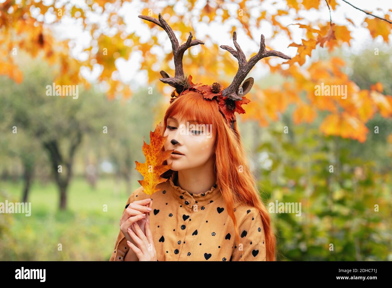 fairy woman with deer horns in autumn forest. Face painting. Beautiful ...