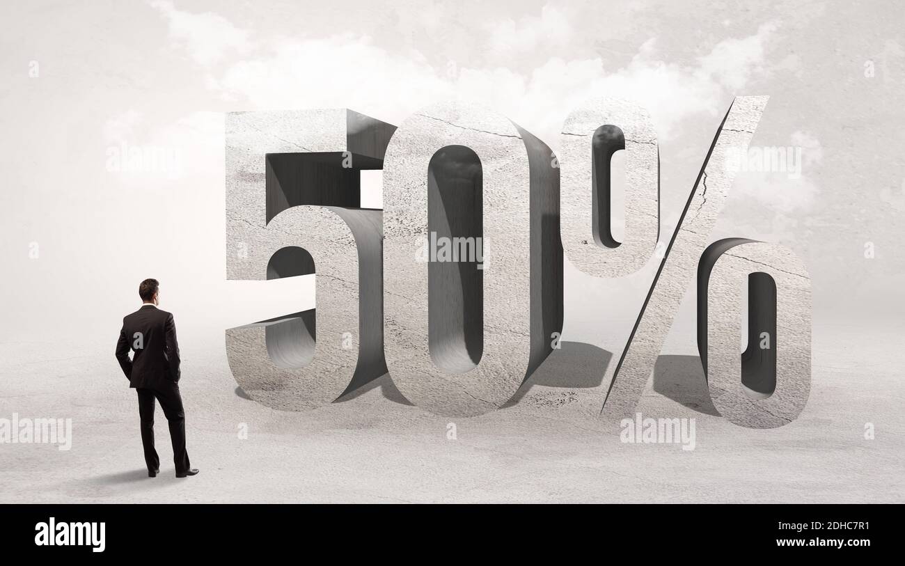 Rear view of a businessman standing in front of 50% abbreviation ...
