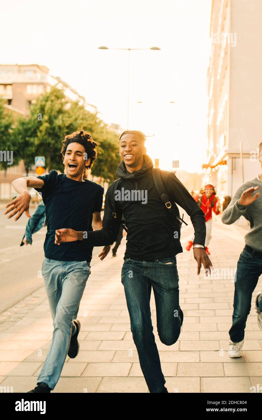 Back view of four friends running hi-res stock photography and images ...