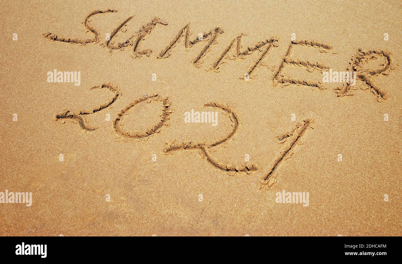 Summer 2021 etched in sand Stock Photo - Alamy
