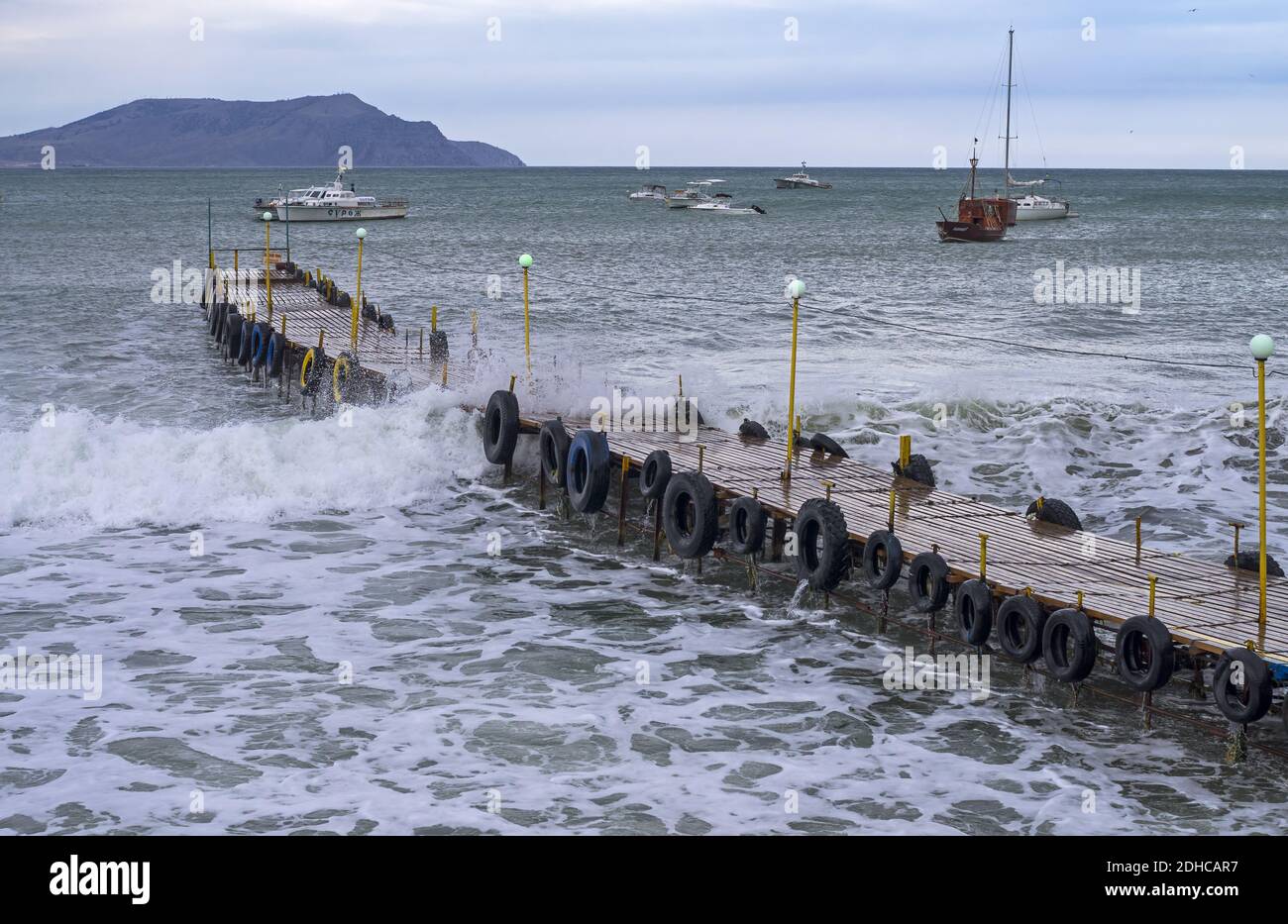 Wave fills a small jetty Stock Photo - Alamy