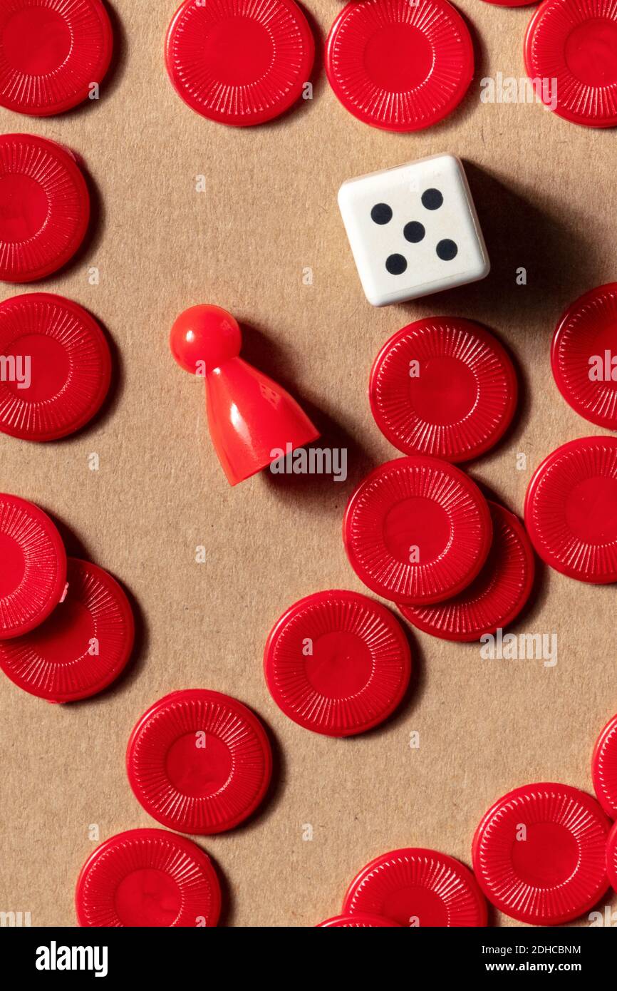 Playing board games detail, overhead flat lay shot of a die with a red ...