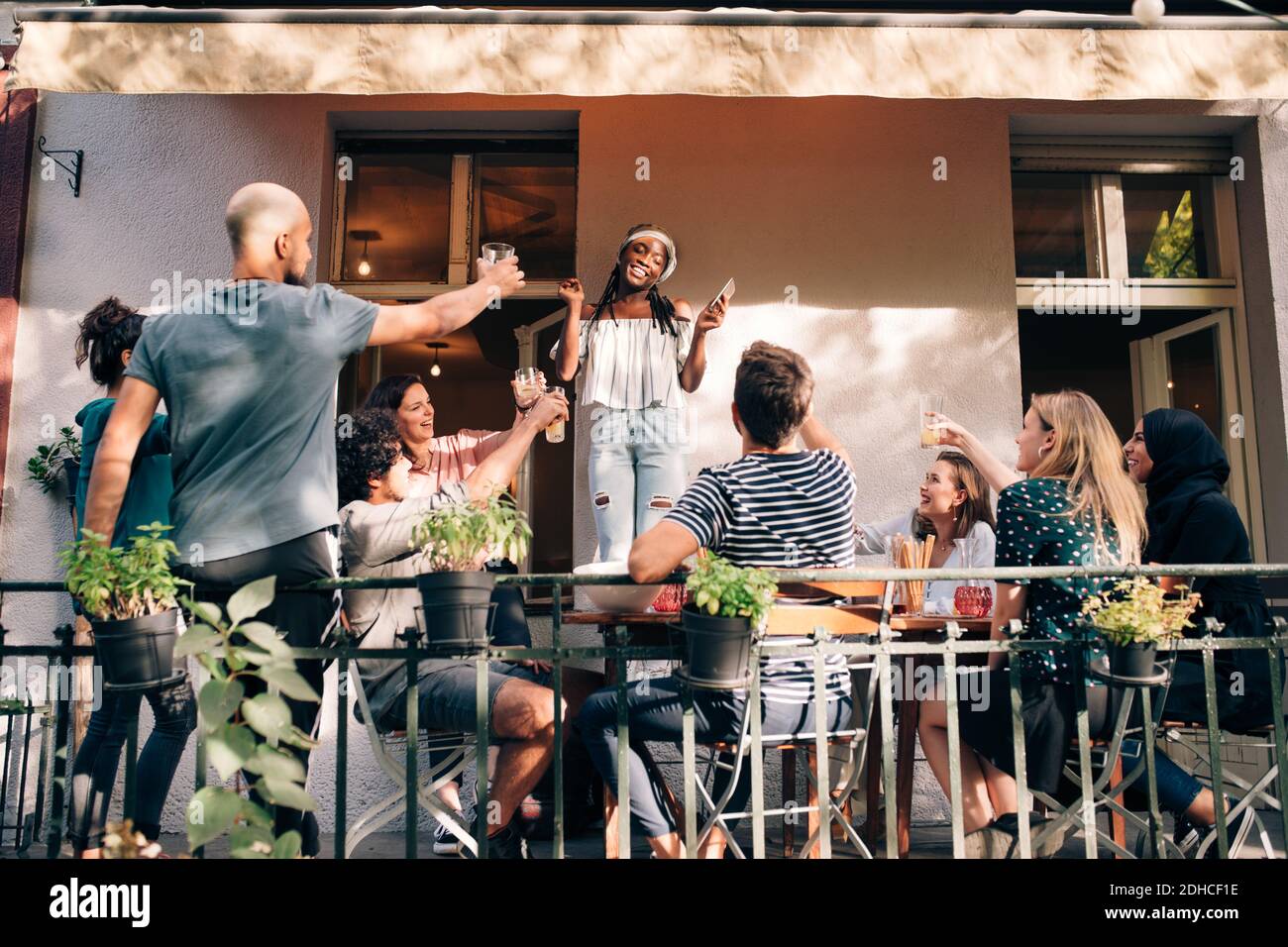 Multi-ethnic friends celebrating at balcony during party Stock Photo ...