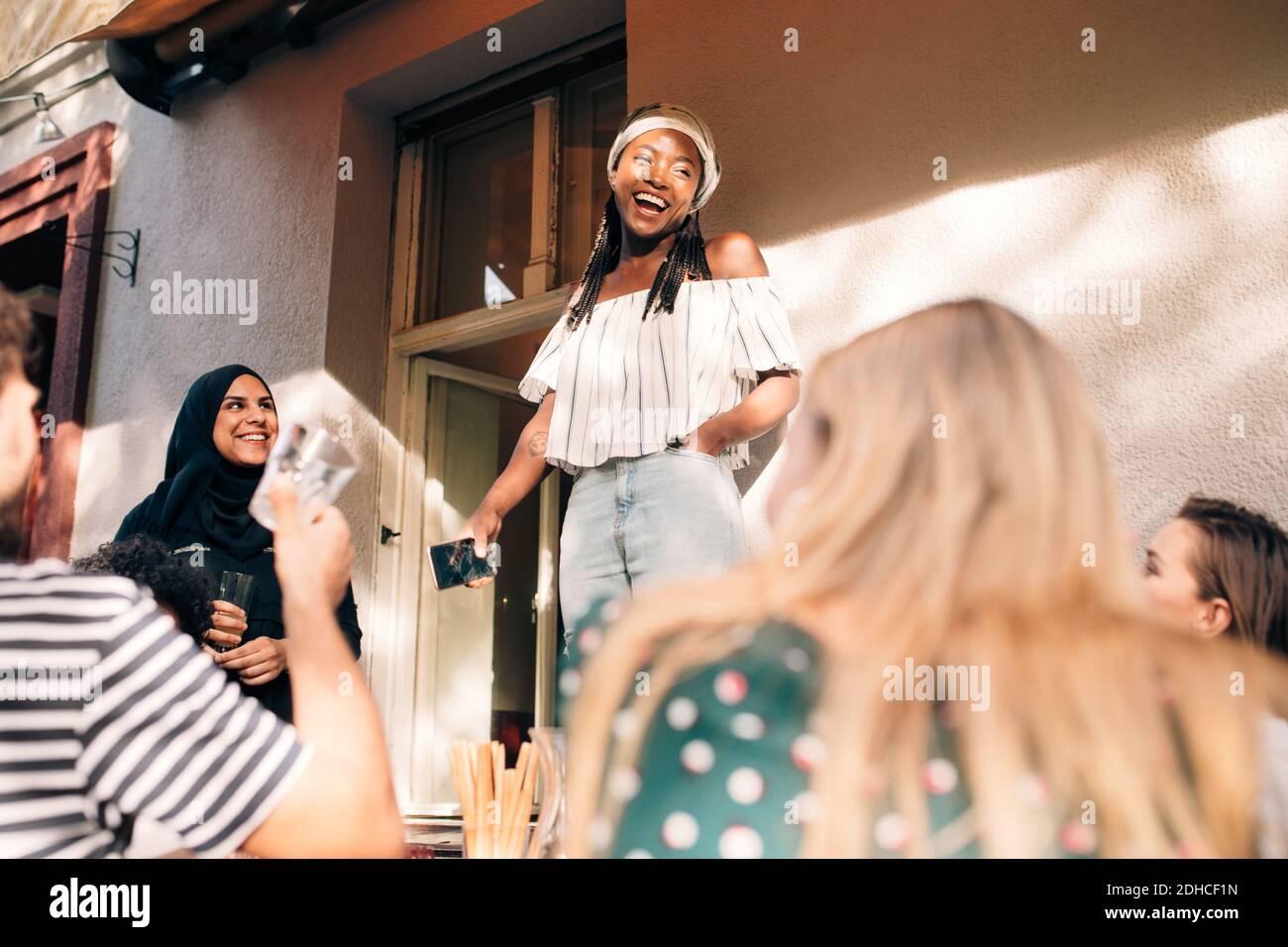 Multi-ethnic young friends celebrating at balcony during party Stock ...