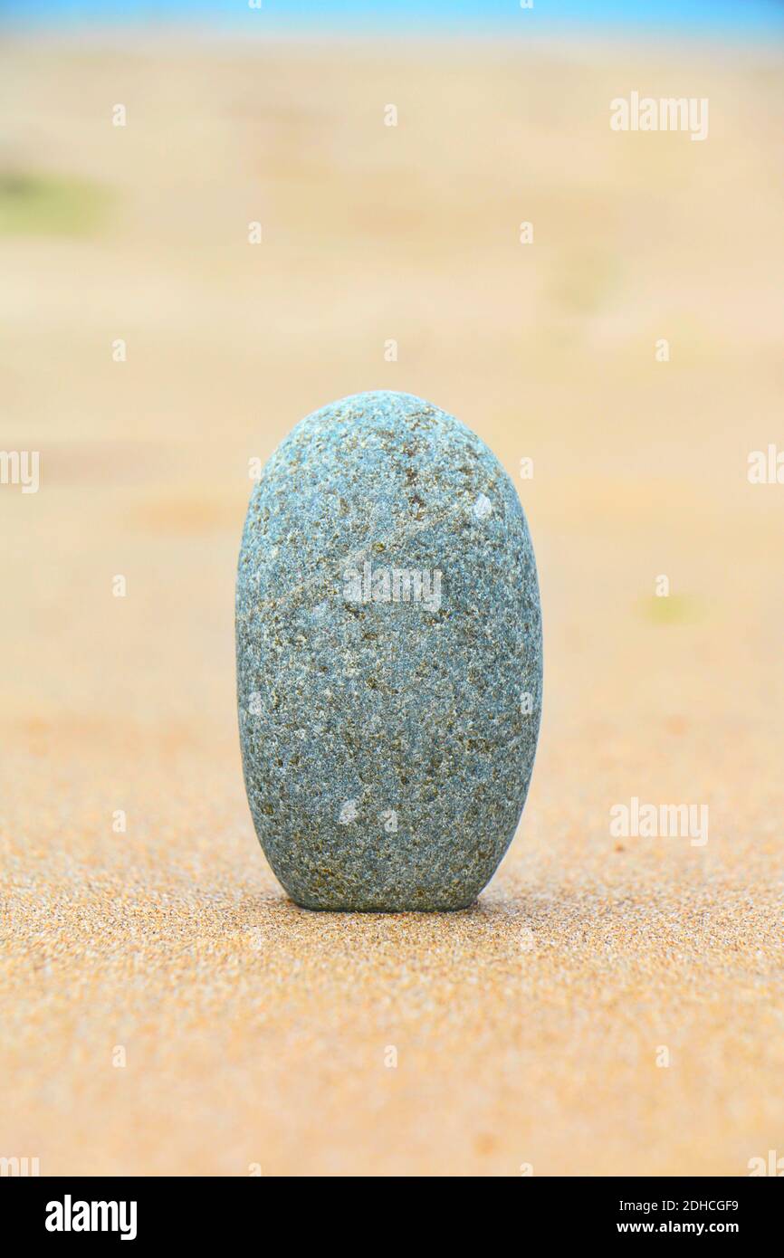 Single round stone on the beach Stock Photo - Alamy
