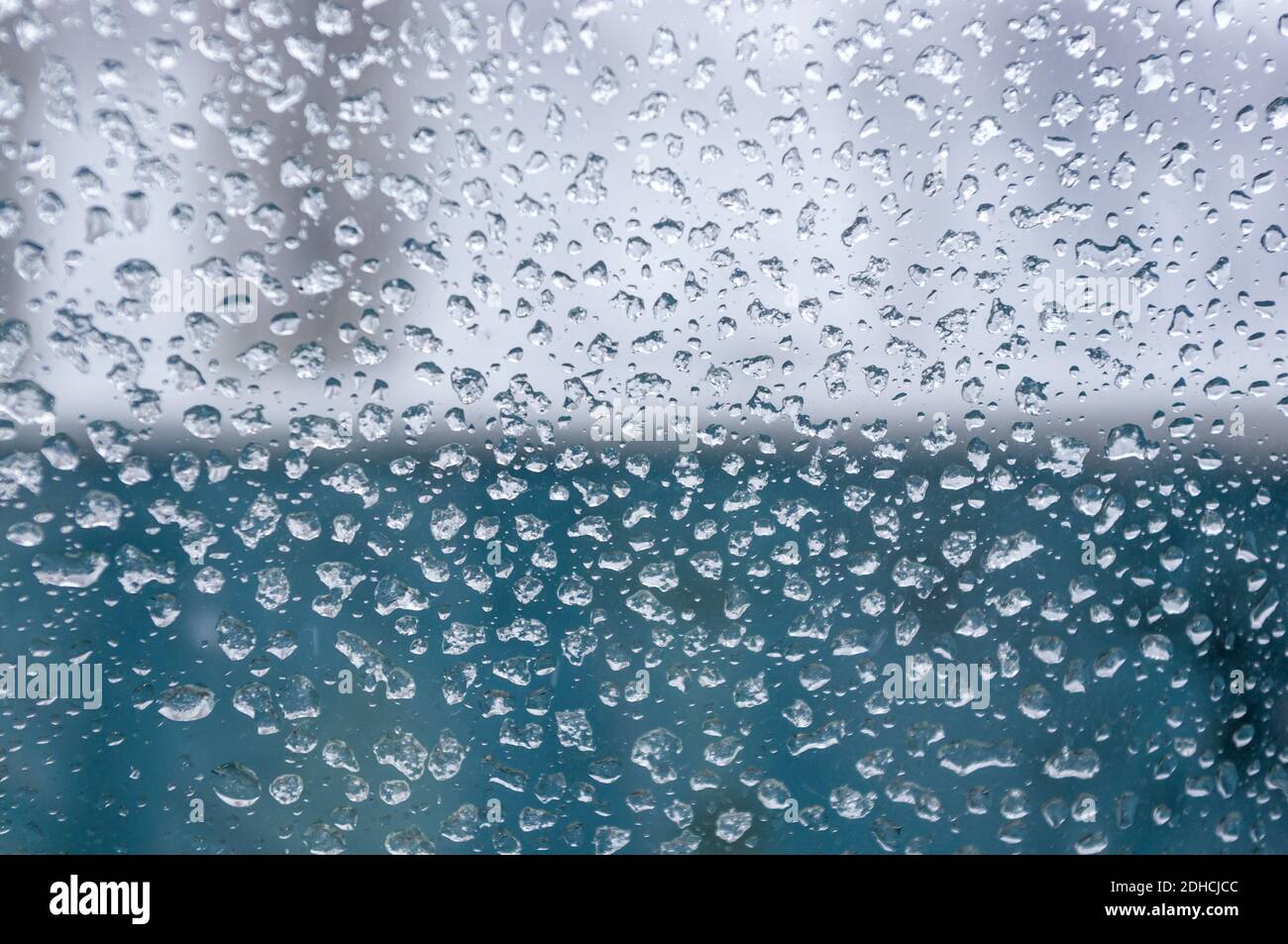 Melting snow on the glass, drops of water condensation on the window ...