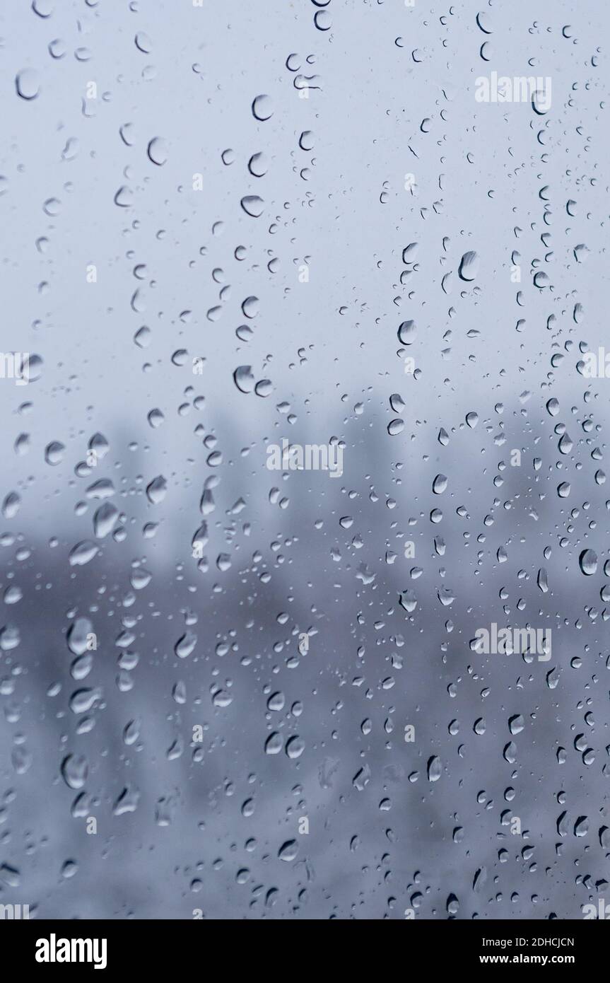 Melting snow on the glass, drops of water condensation on the window ...