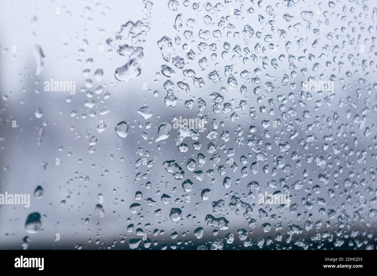 Melting snow on the glass, drops of water condensation on the window ...