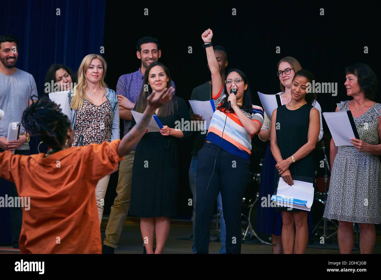 Choir singer with friends performing on stage in auditorium Stock Photo ...