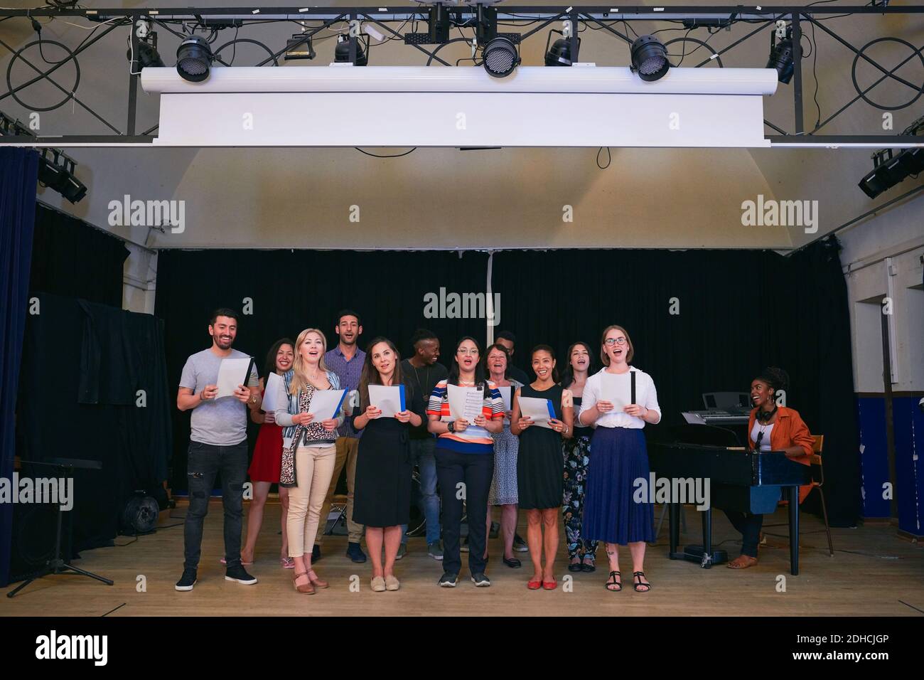 Choir members performing on stage in school auditorium Stock Photo - Alamy