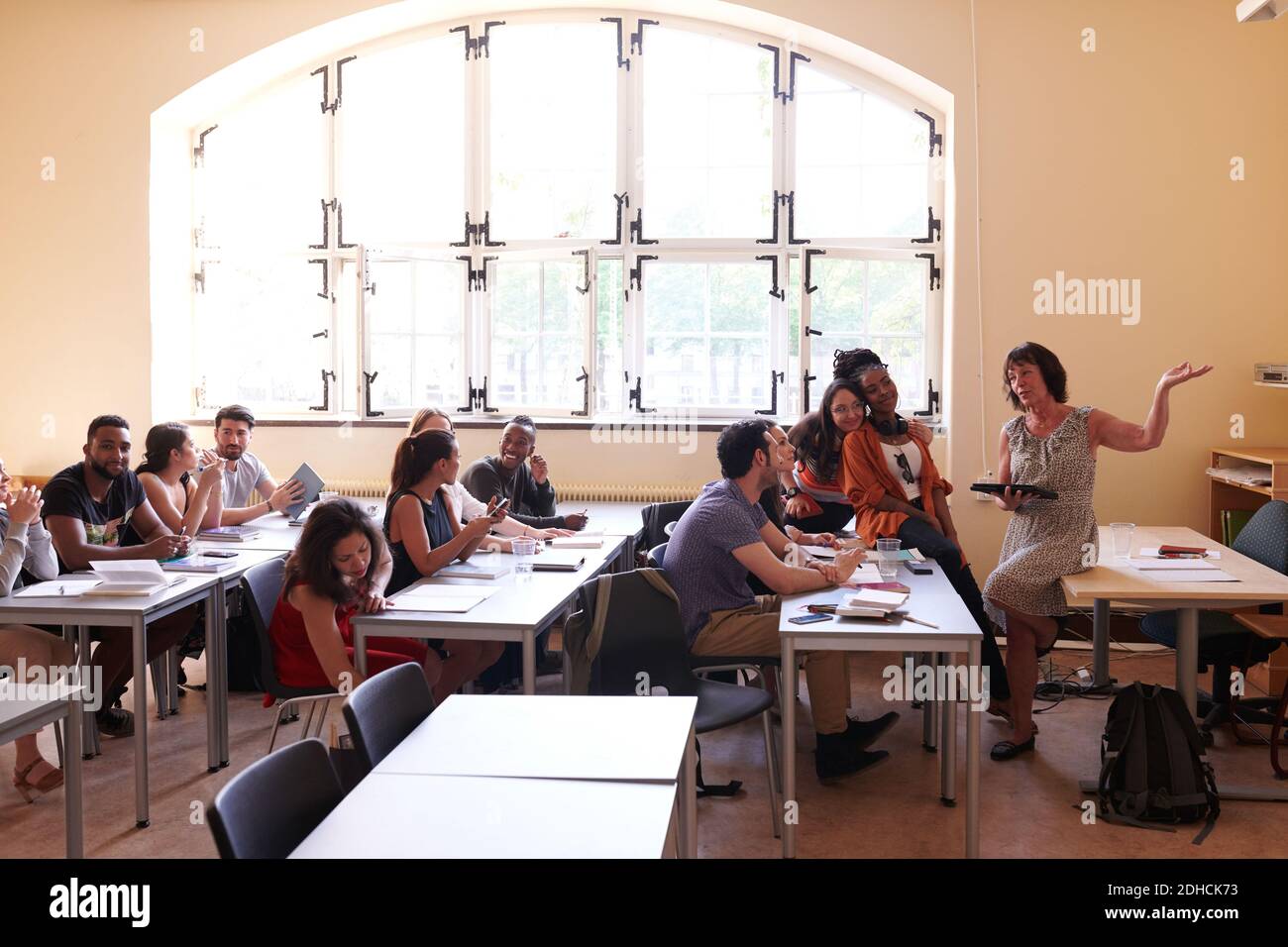 Teacher Teaching To Students In Classroom Stock Photo Alamy