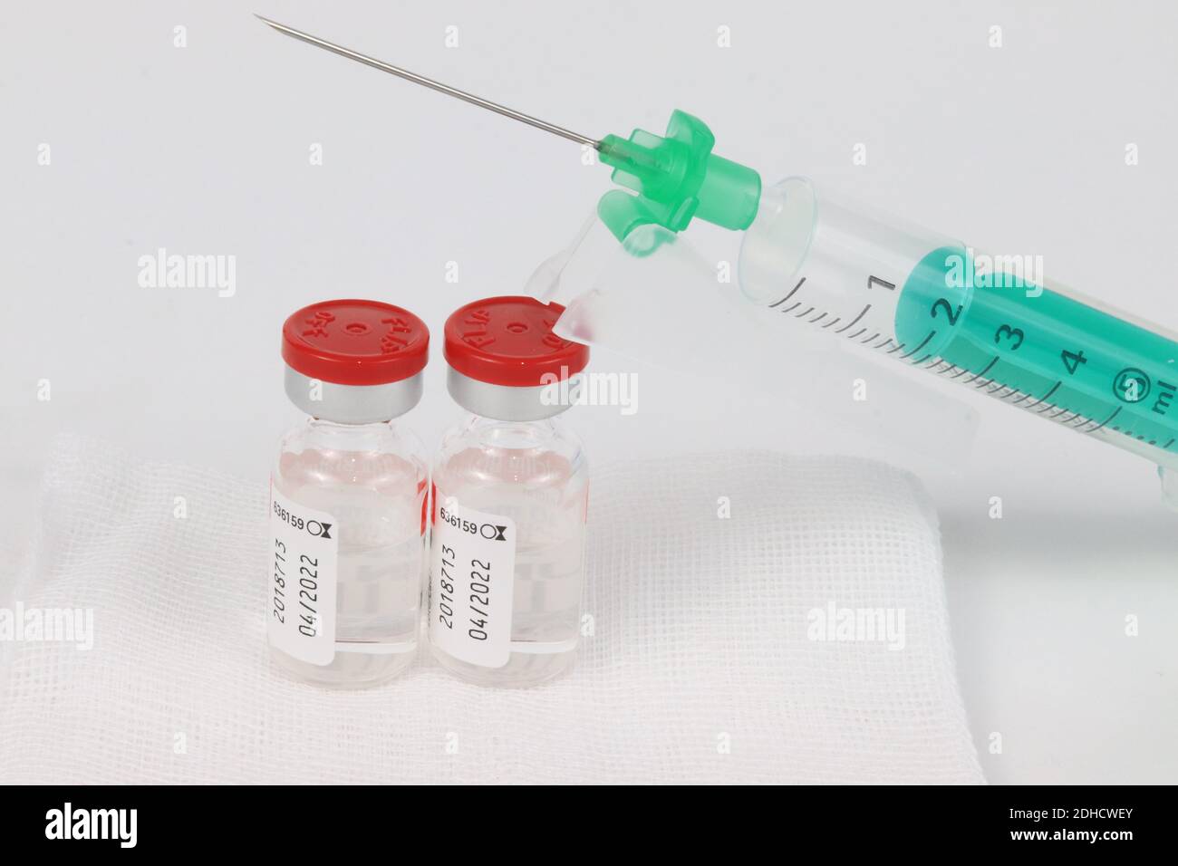 A shot of two vaccine containers, a napkin and syringe Stock Photo - Alamy