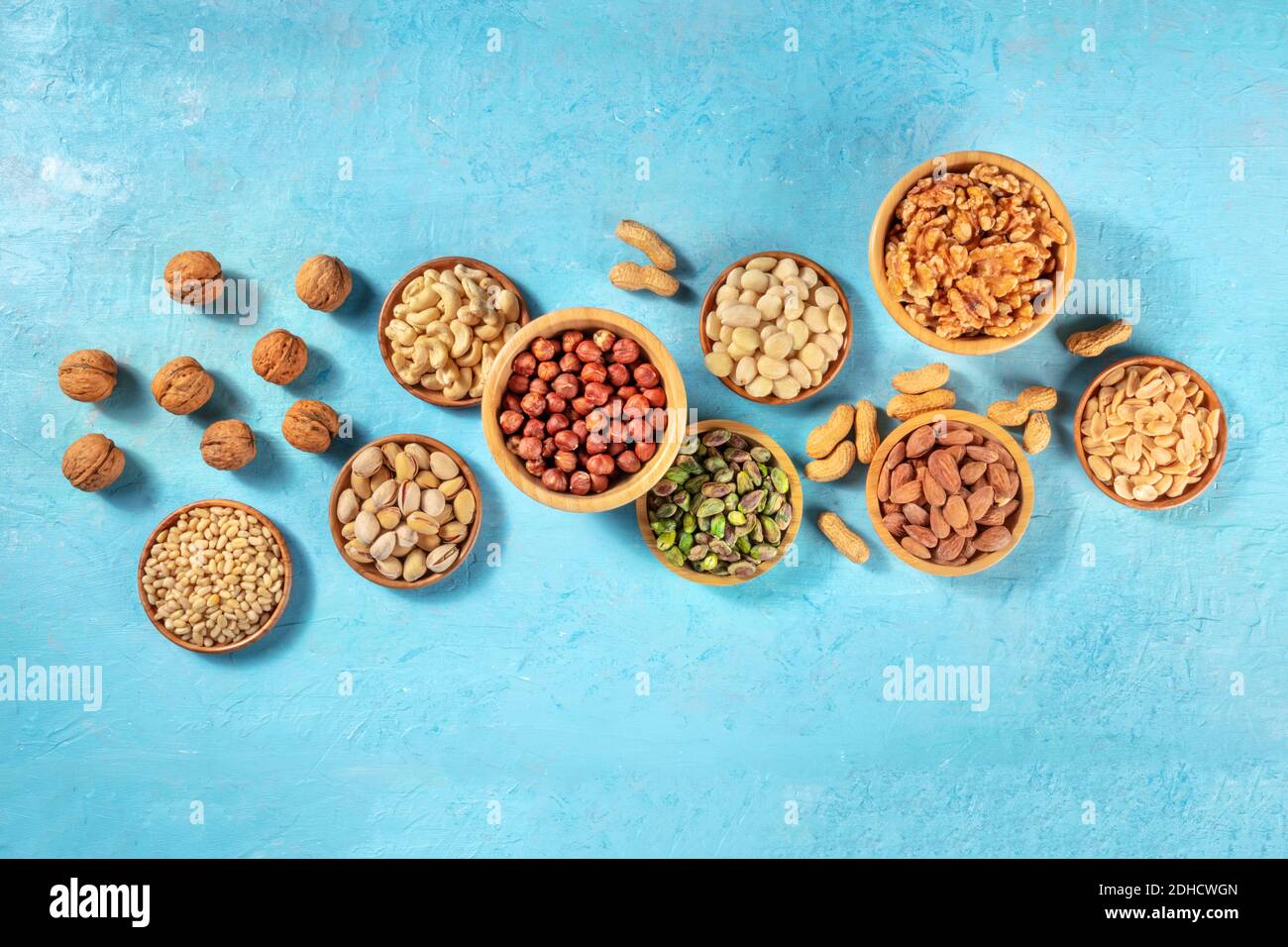 Nuts variety. Many different nuts, shot from the top on a vibrant blue ...