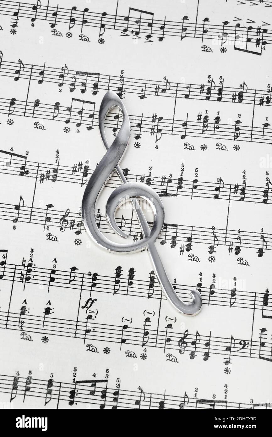 Treble clef on music sheet - musical background Stock Photo - Alamy