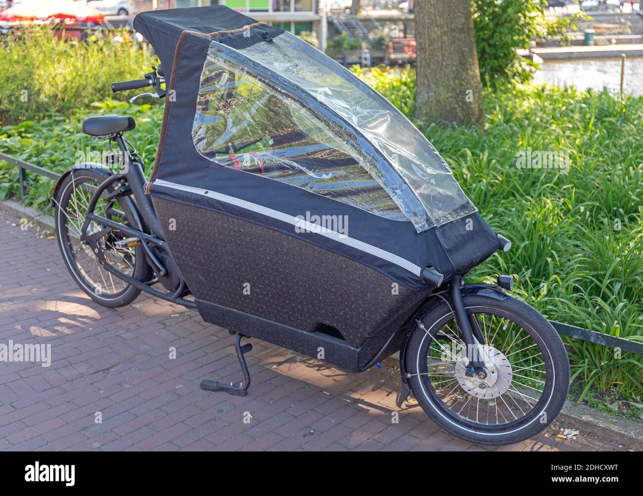 Electric Bicycle With Cabin for Kids Transport in Amsterdam Stock Photo ...