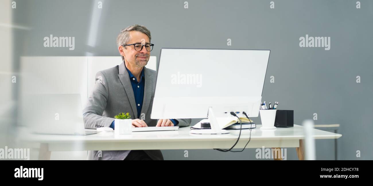 Happy Professional Man Employee Using Computer For Work Stock Photo - Alamy