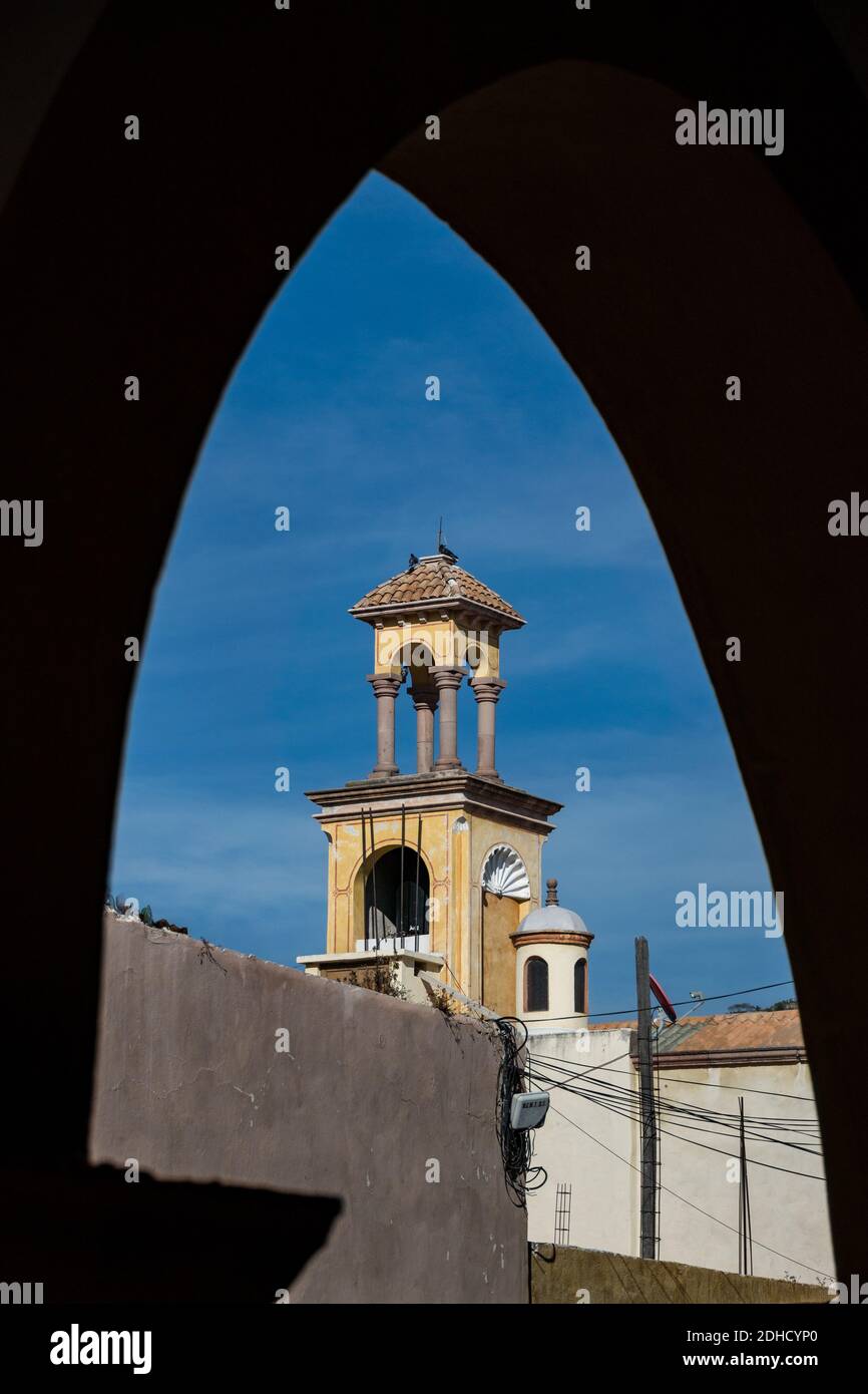 A decorative tower framed in an archway in the beautiful colonial ...