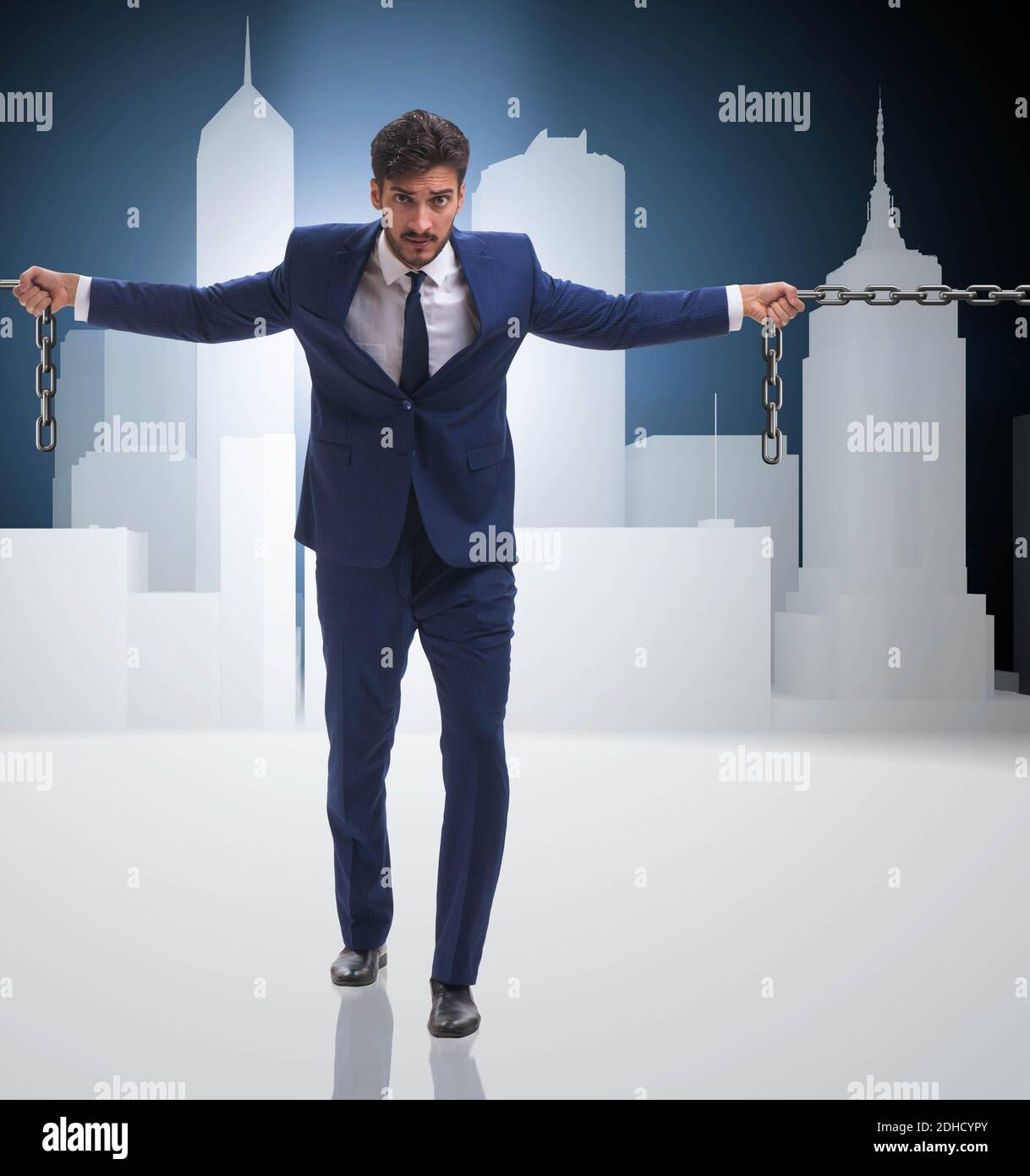 Businessman holding chains in business concept Stock Photo - Alamy