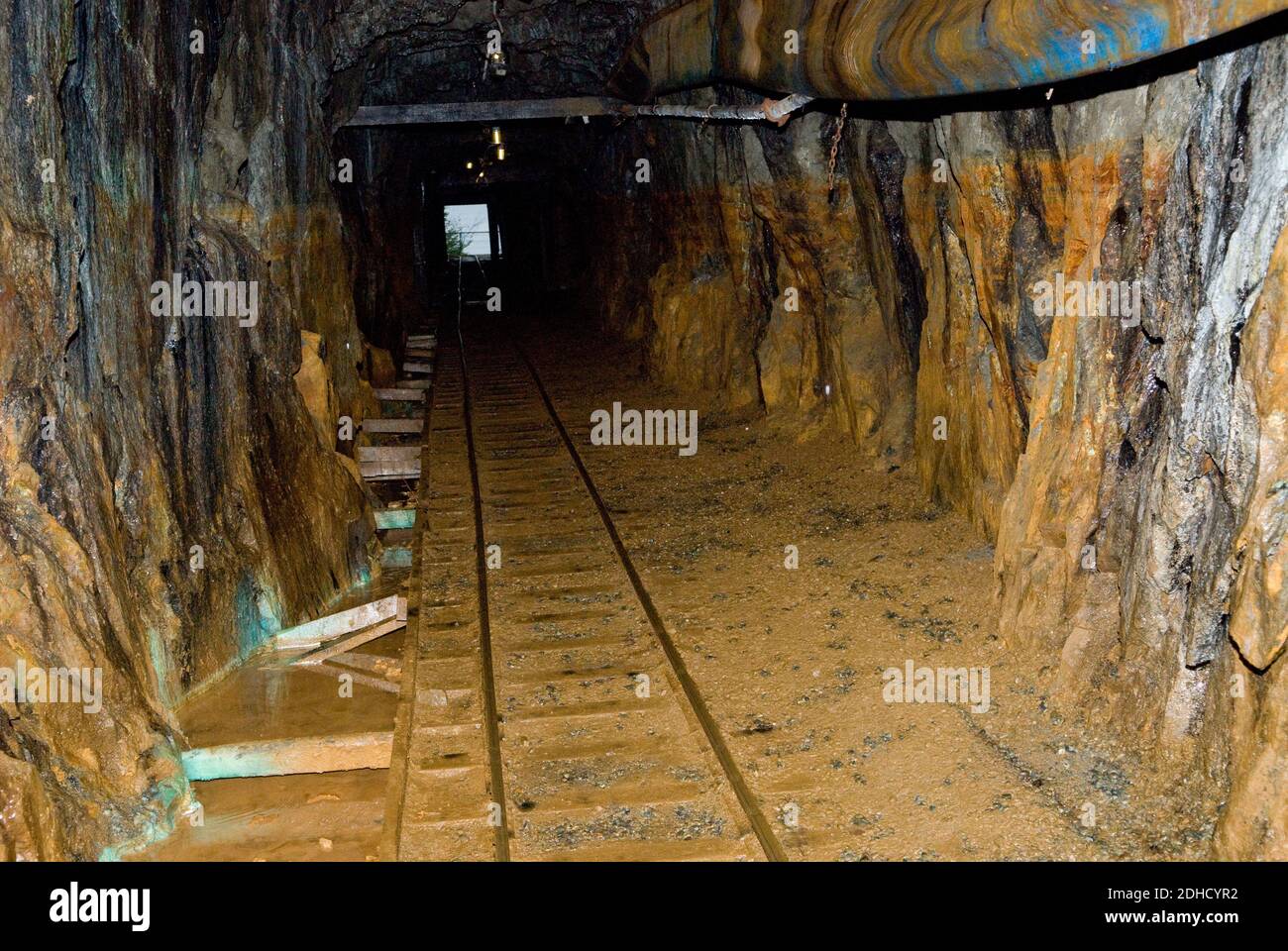 A long underground coal mining tunnel surrounded by rocks Stock Photo ...