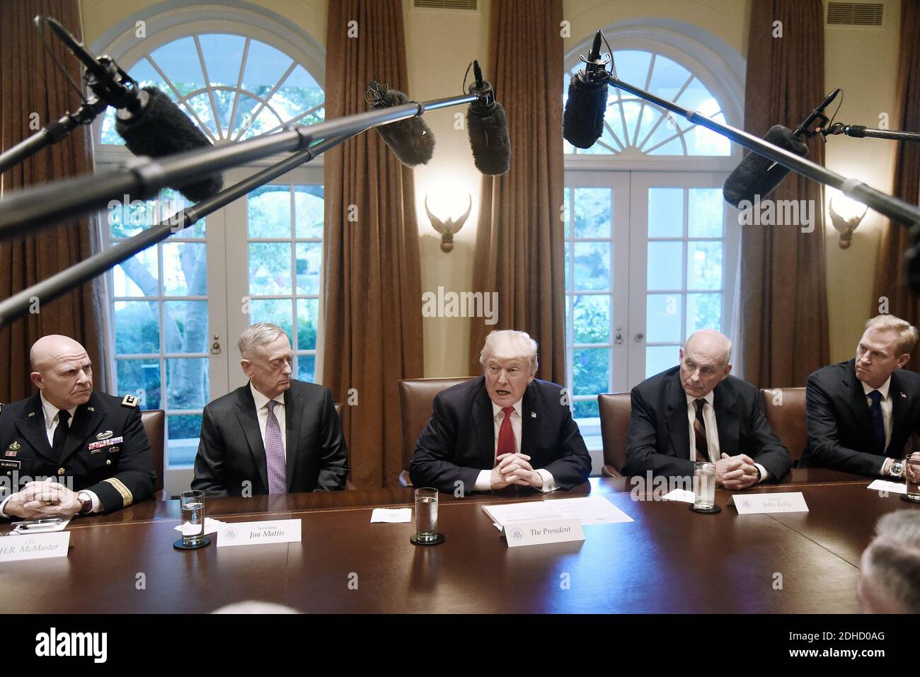 U.S. President Donald Trump flanked by Defense Secretary Jim Mattis (L ...