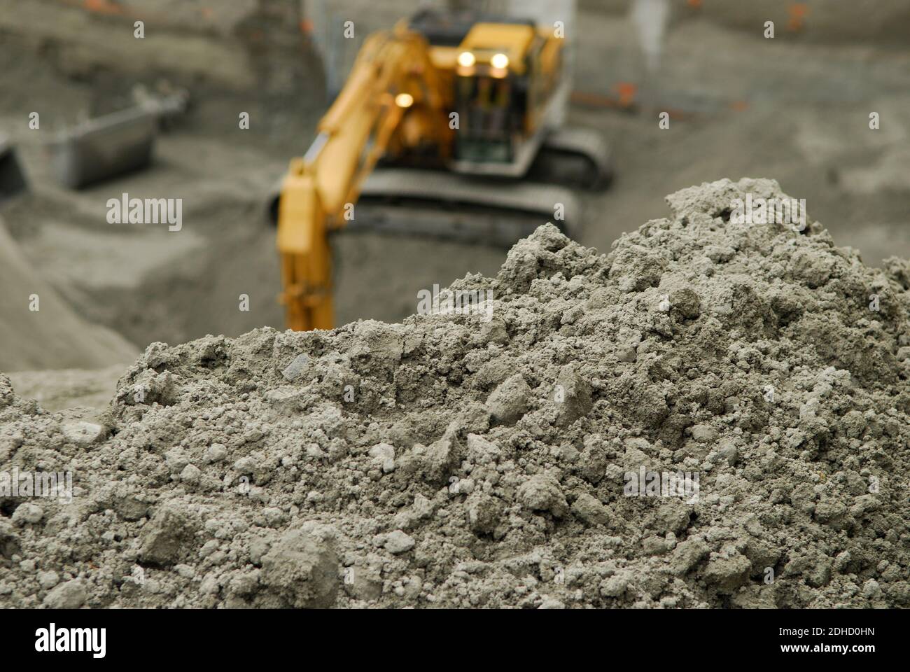 a backhoe in the background digging a foundation Stock Photo - Alamy